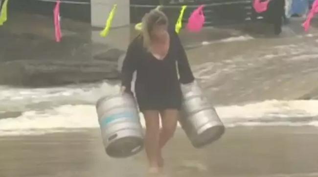 Woman Jumps Into Flooded Ocean To Save Beer Kegs