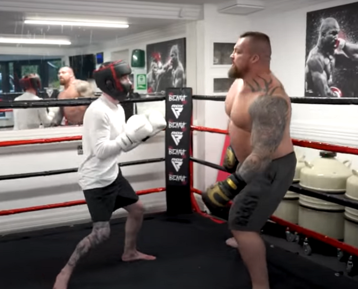 Former Olympian Takes A Punch From The World's Former Strongest Man