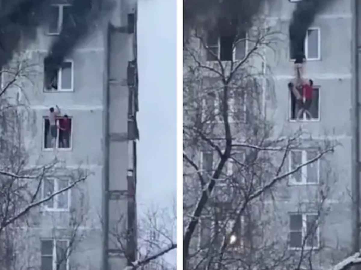 Two Men Rescue A Girl From A Burning Building In Russia