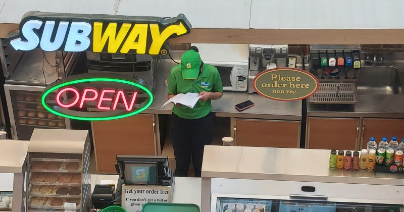 Photo Of Subway Employee Studying Behind Counter Goes Viral